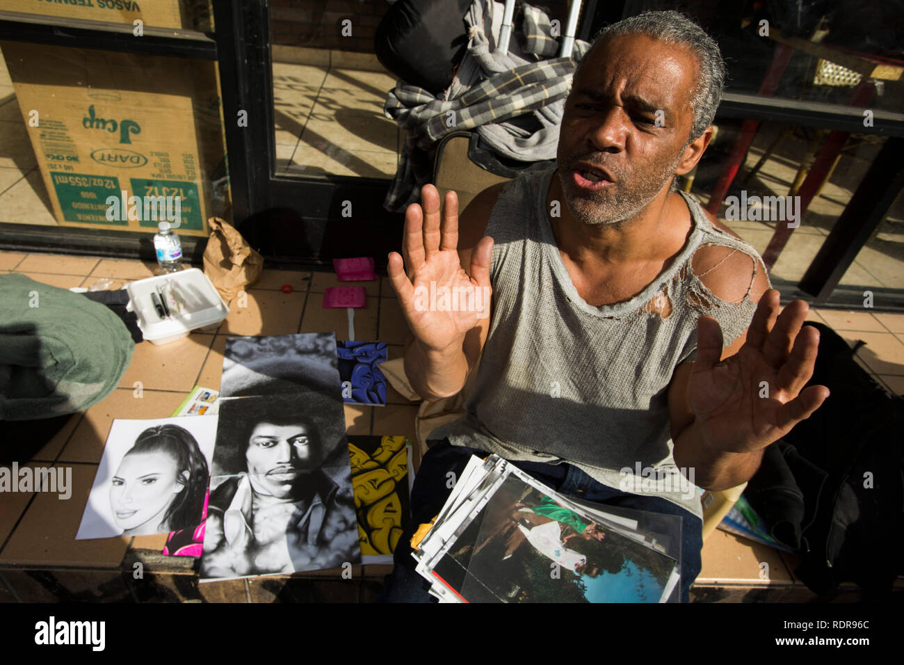 Homeless man showing his art, near The Midnight Mission on Thanksgiving ...