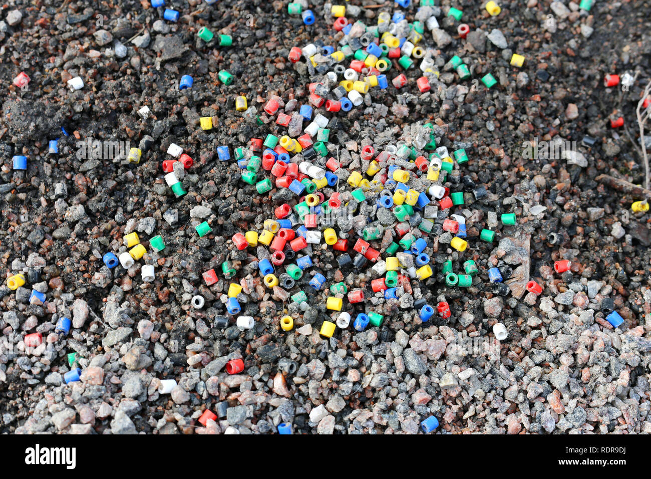 Colorful plastic beads on ground. Plastic is getting to the environment ...