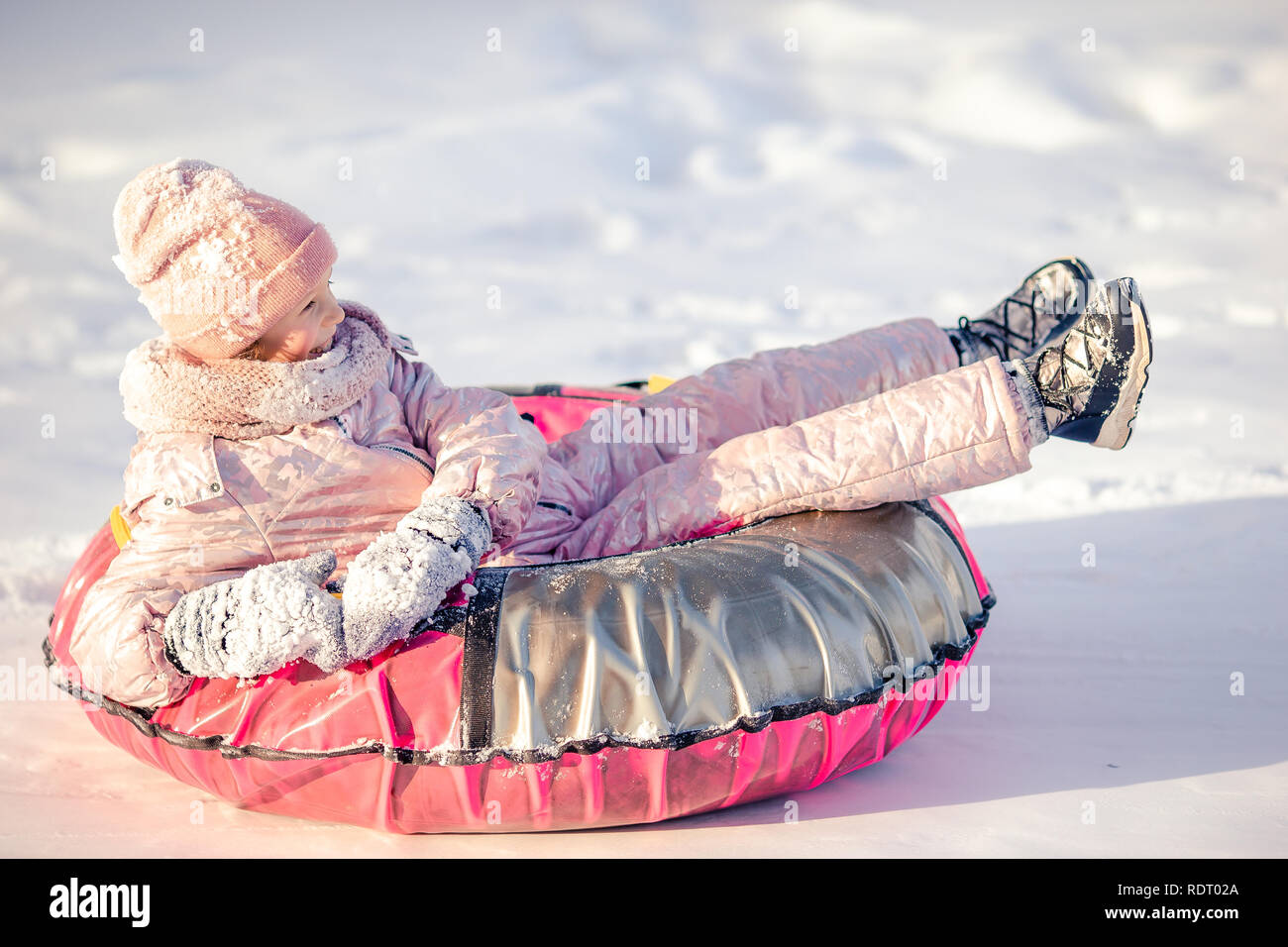 Adorable little happy girl sledding in winter snowy day Stock Photo - Alamy