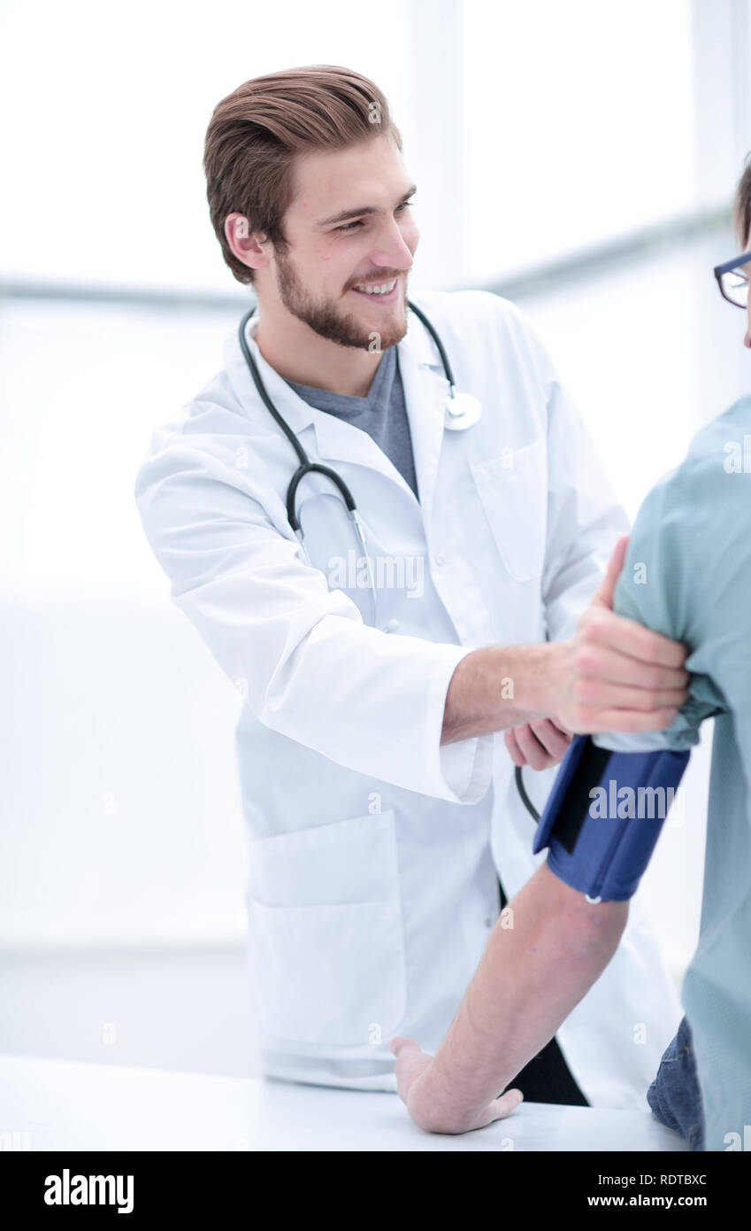 smiling doctor doing a routine inspection of the patient.prevention and ...
