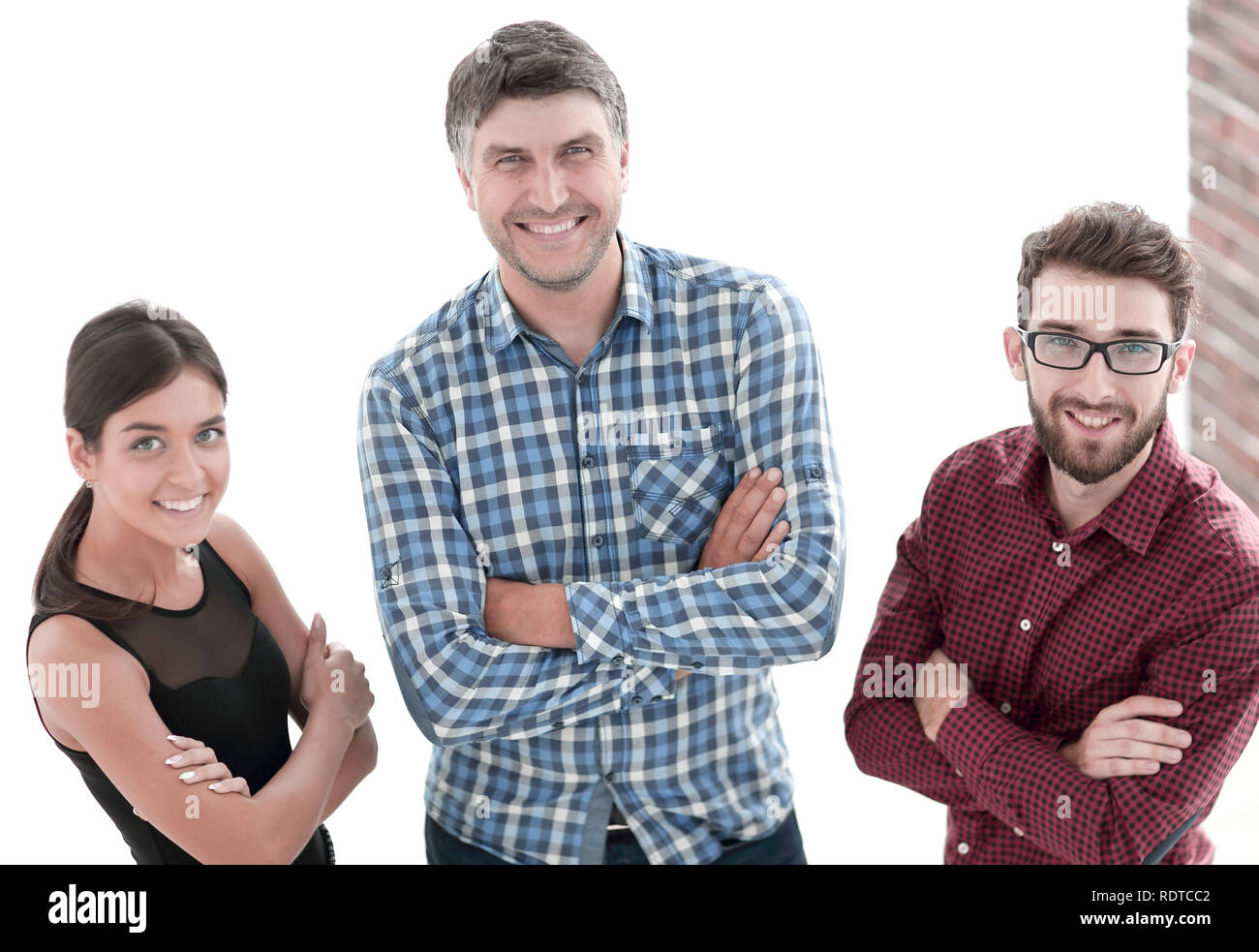 three optimistic office workers smiling in the camera from the top ...