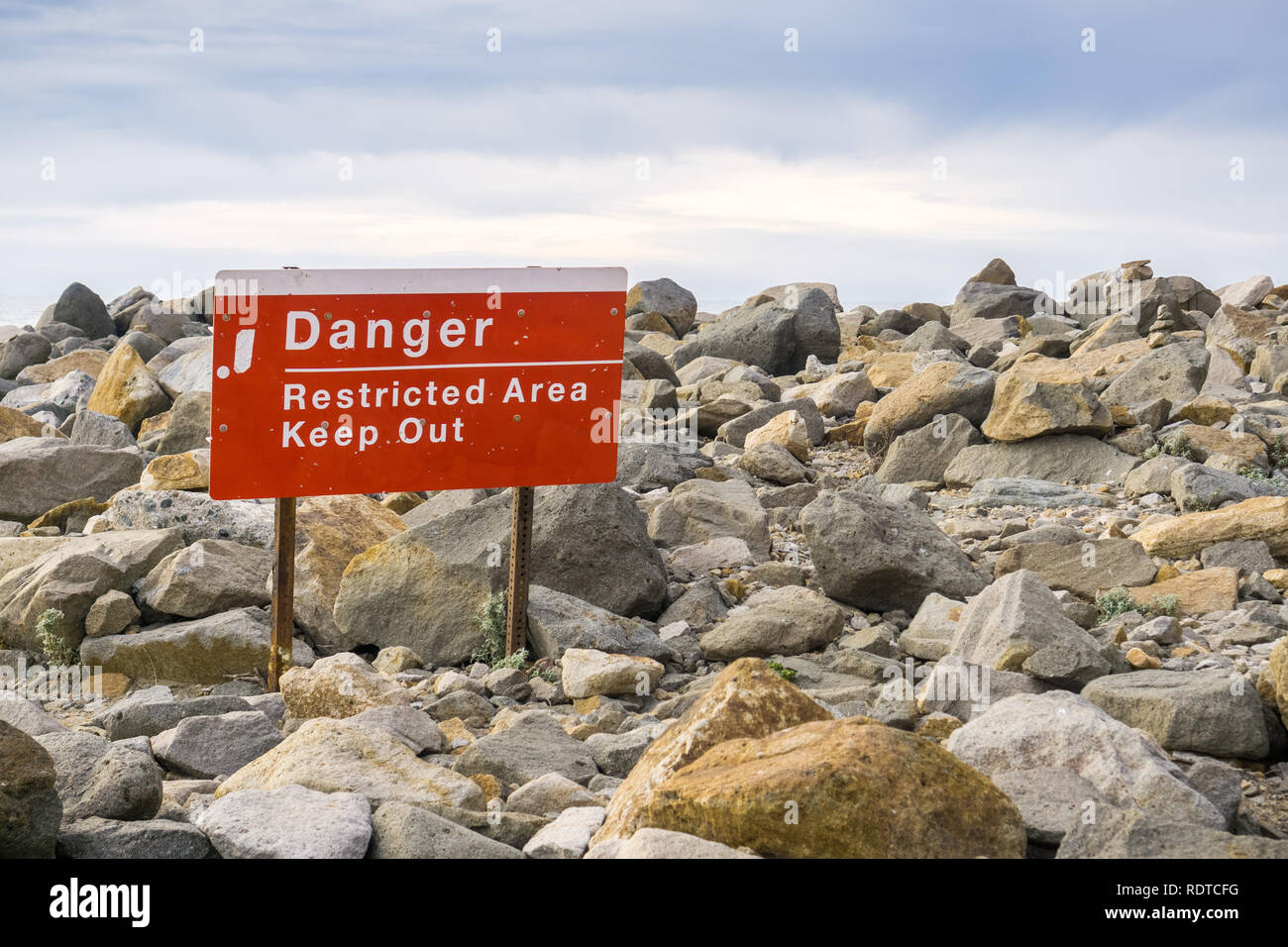 "Danger Restricted Area Keep Out" sign posted on the shoreline of the ...