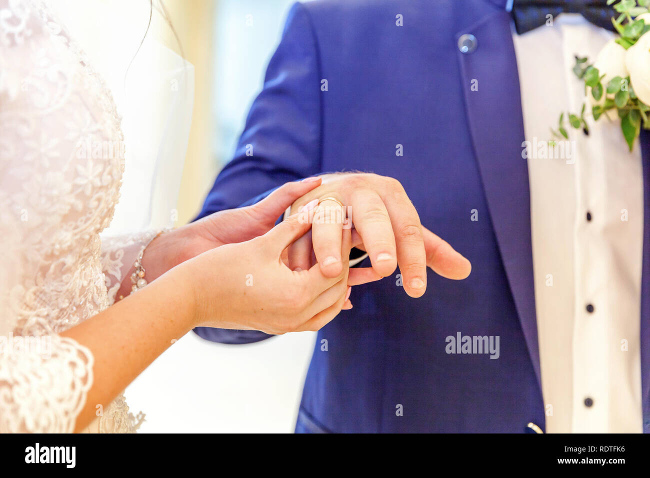 Bride and groom marriage hands with wedding rings. Bride hand putting ...