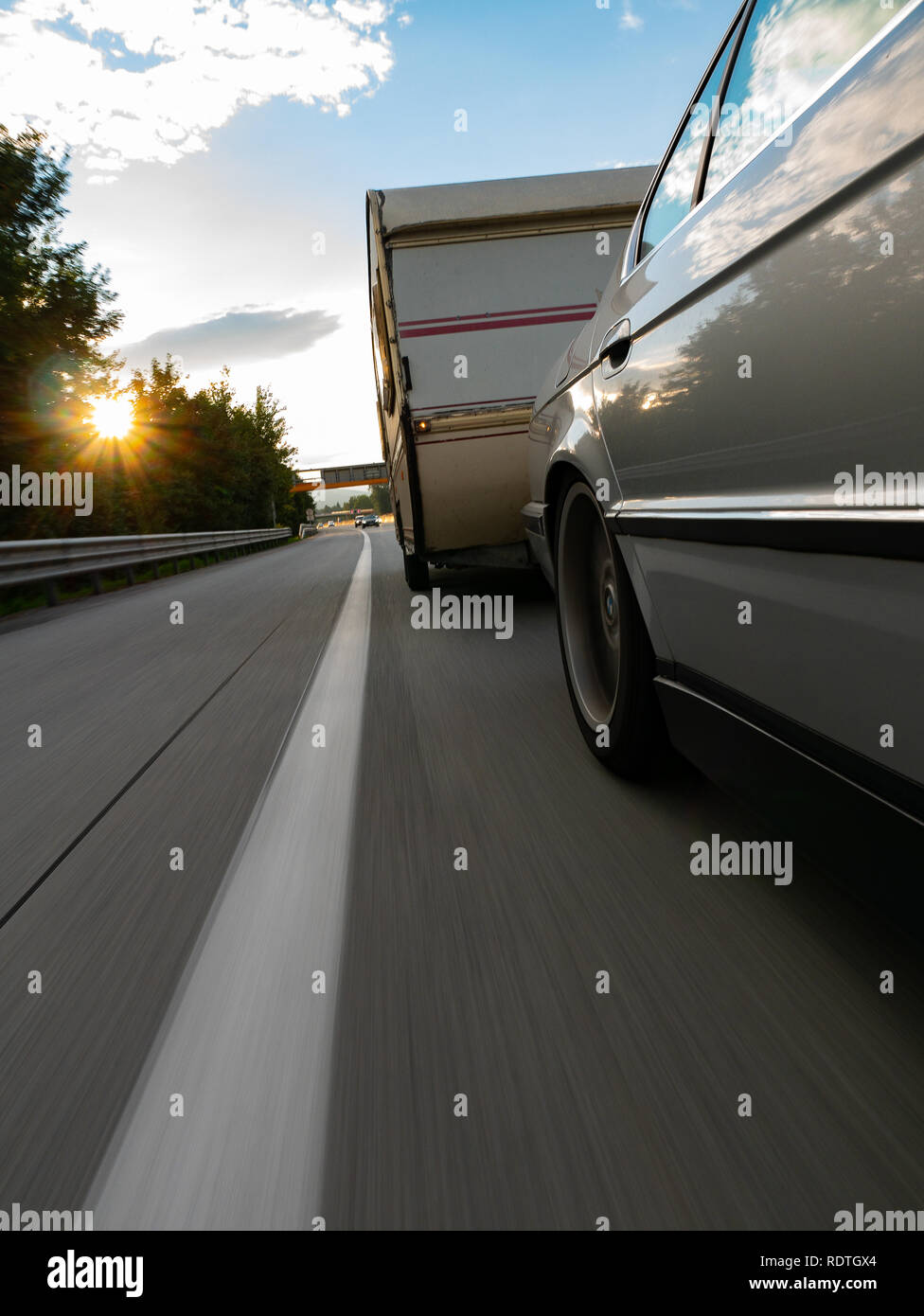 window shot of a driving car with a caravan trailer Stock Photo - Alamy