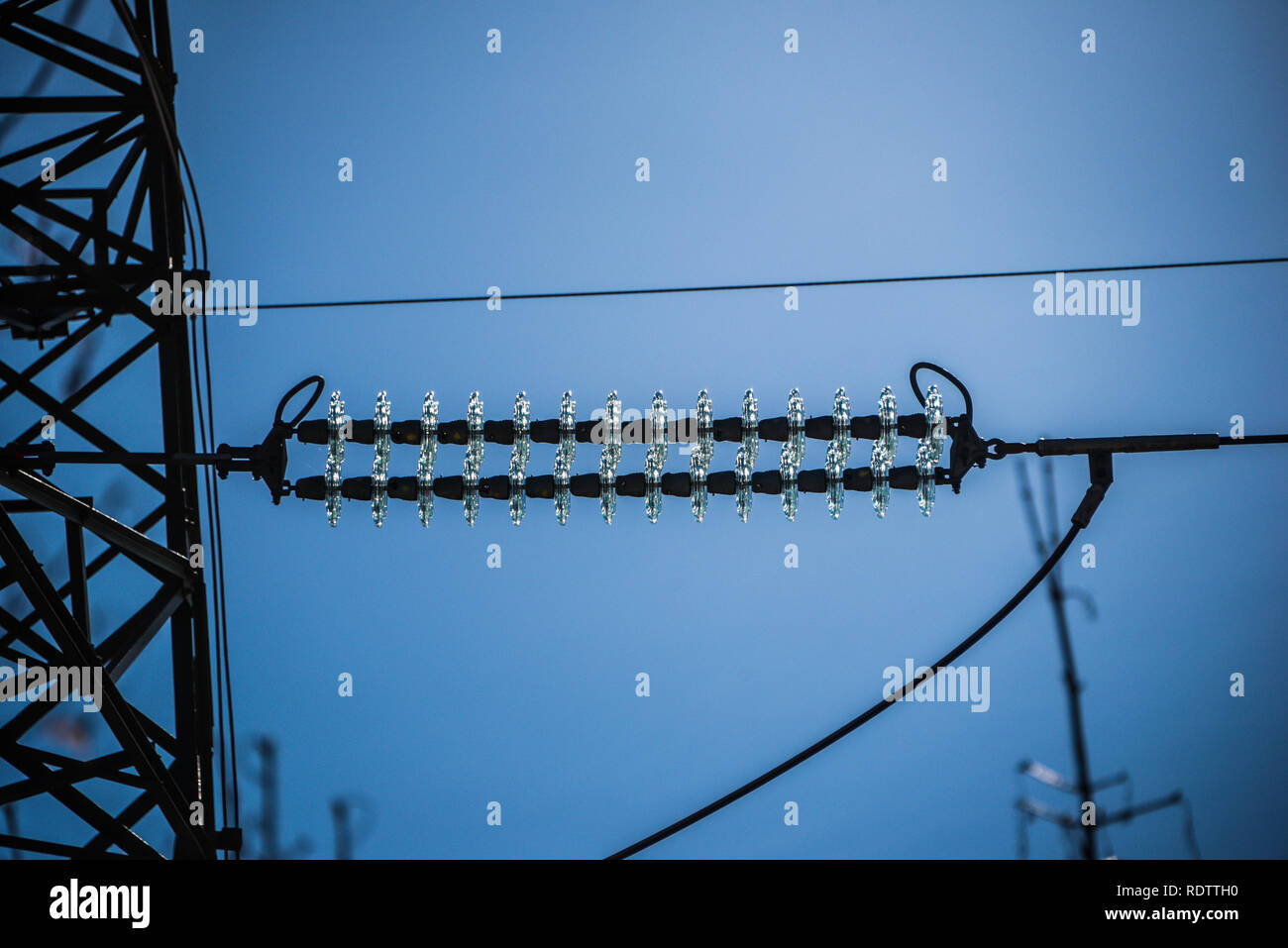 The isolator on High-voltage power line on electricity pylons in the ...