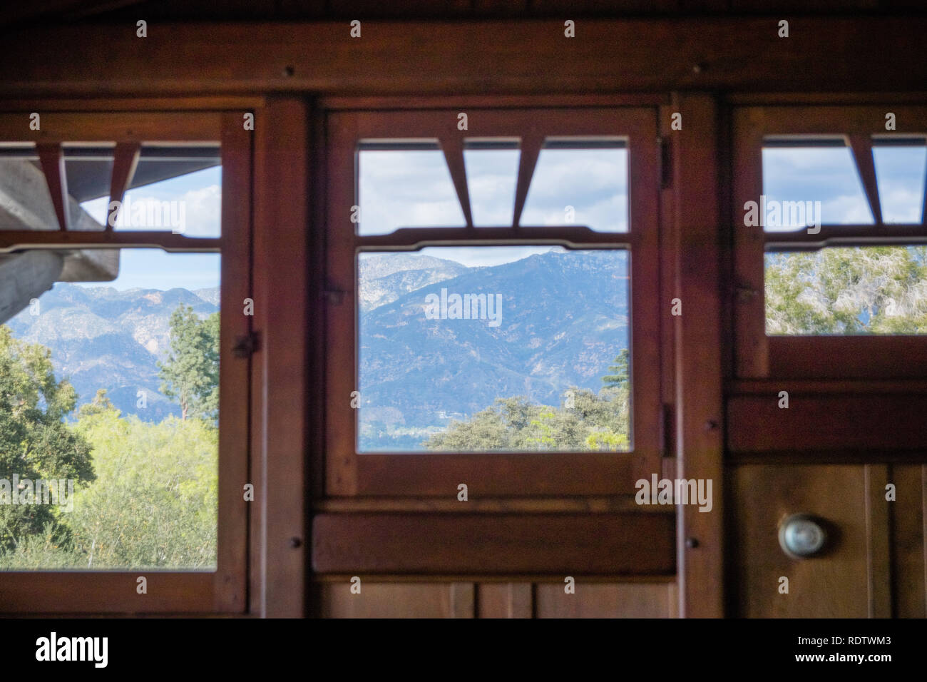 Mountain landscape visible through wooden framed windows; focus on the ...