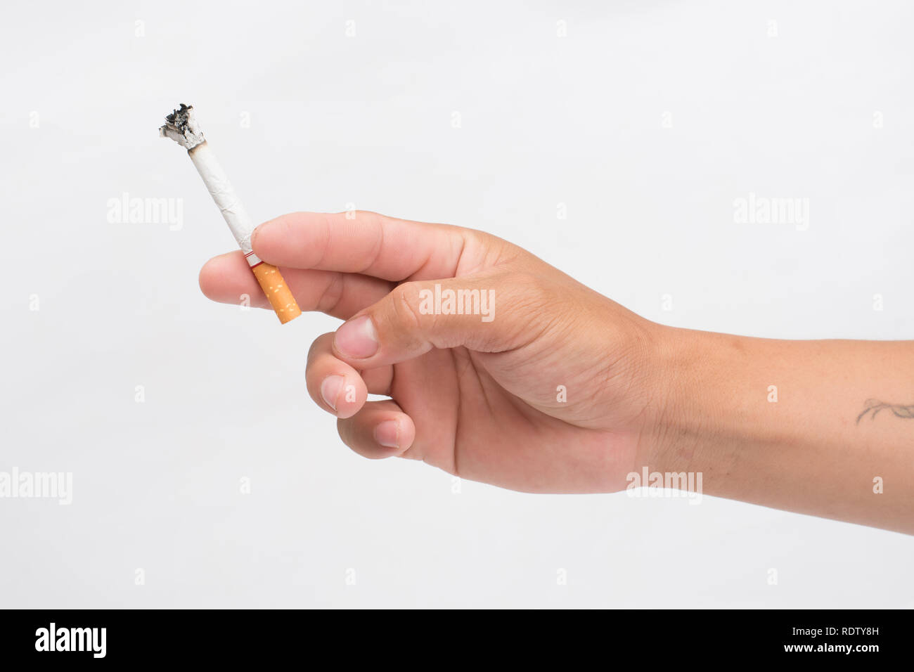 Close up male hand holding a cigarette isolated on white background ...