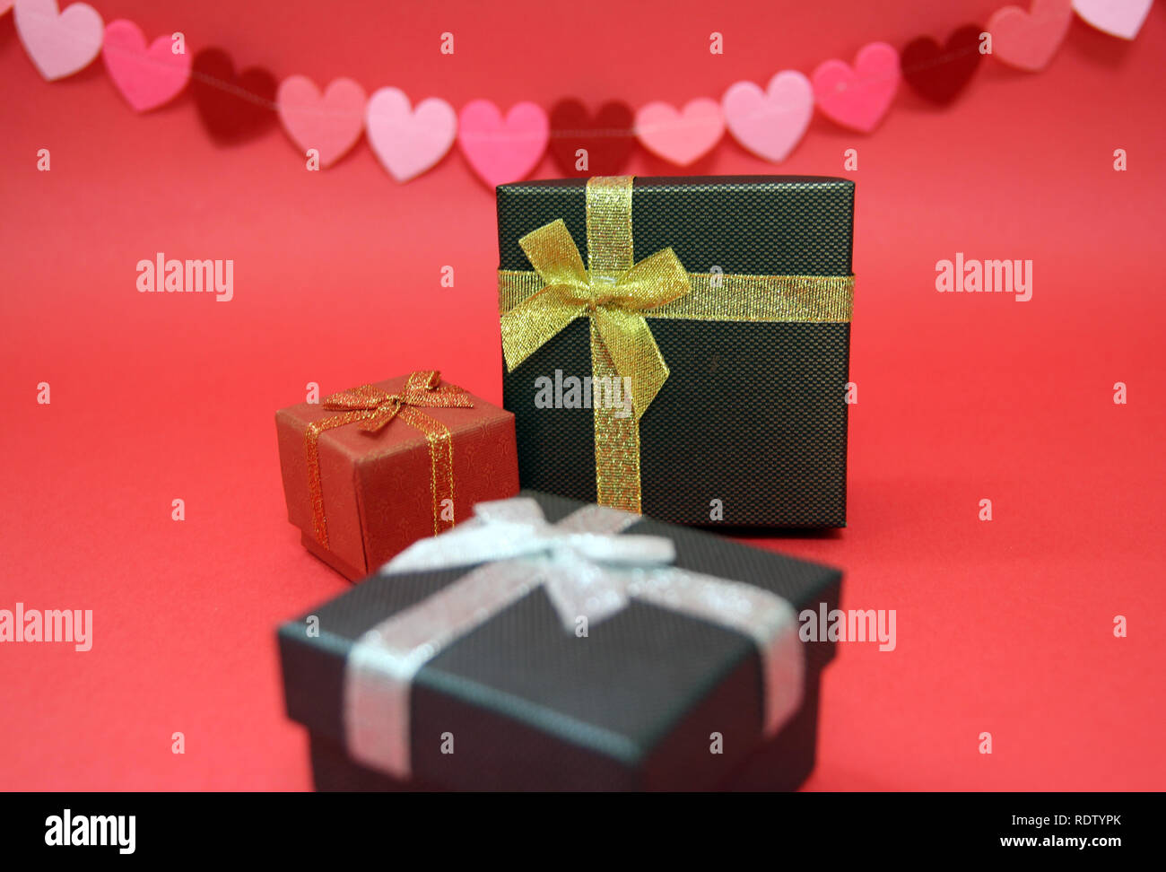 Gift box with red theme Stock Photo - Alamy