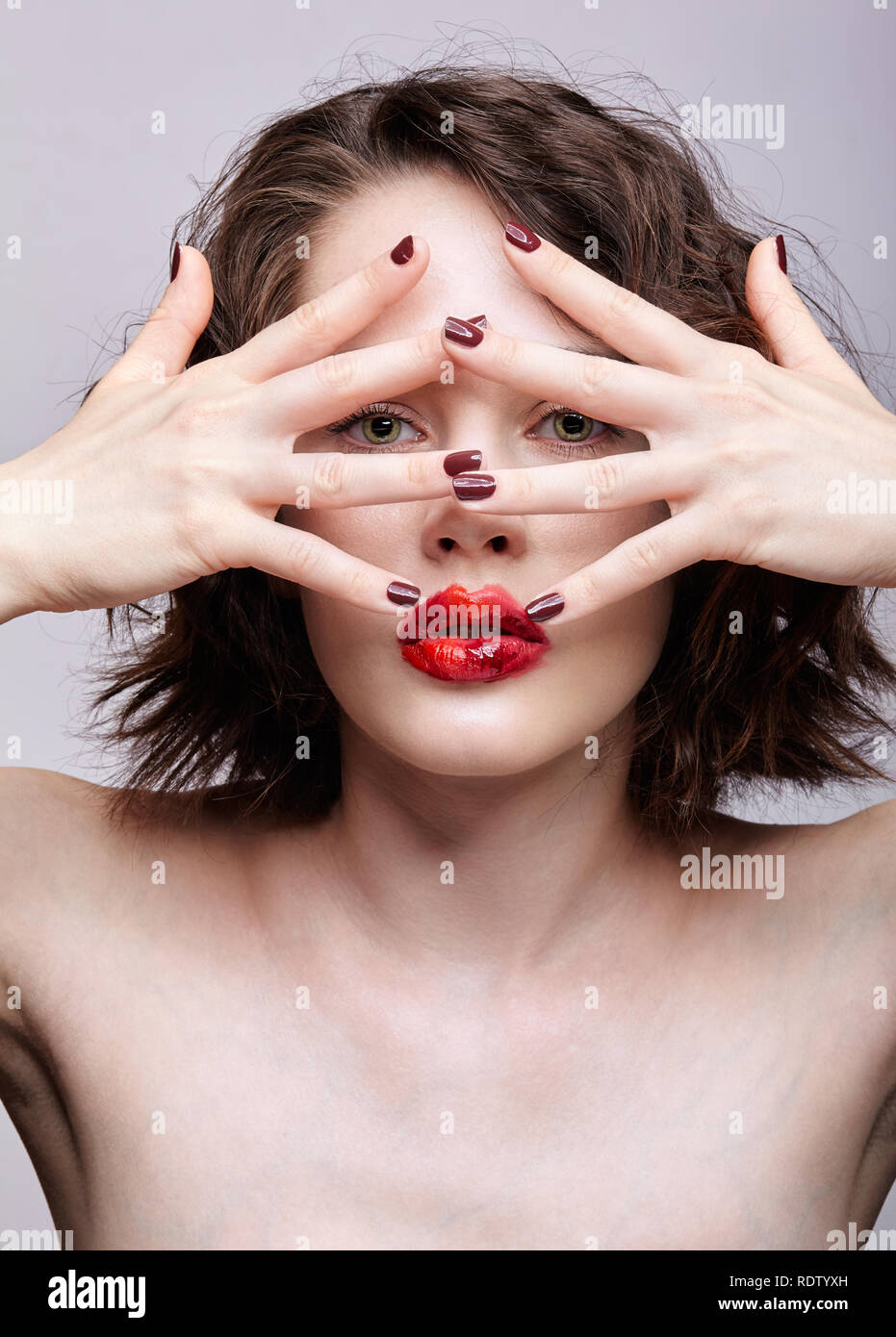 Beauty portrait of young woman with hands on face. Brunette girl with ...