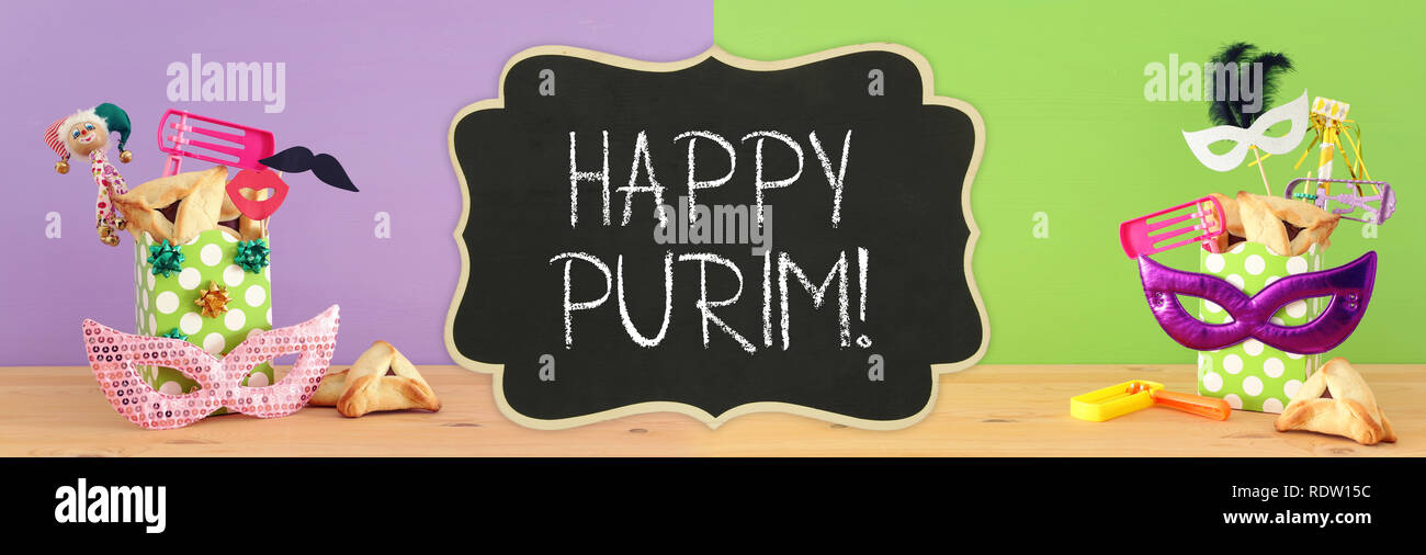 Purim celebration concept (jewish carnival holiday) over wooden table ...