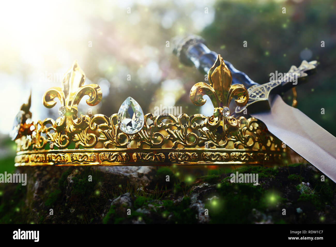mysterious and magical photo of silver king crown and sword over the ...