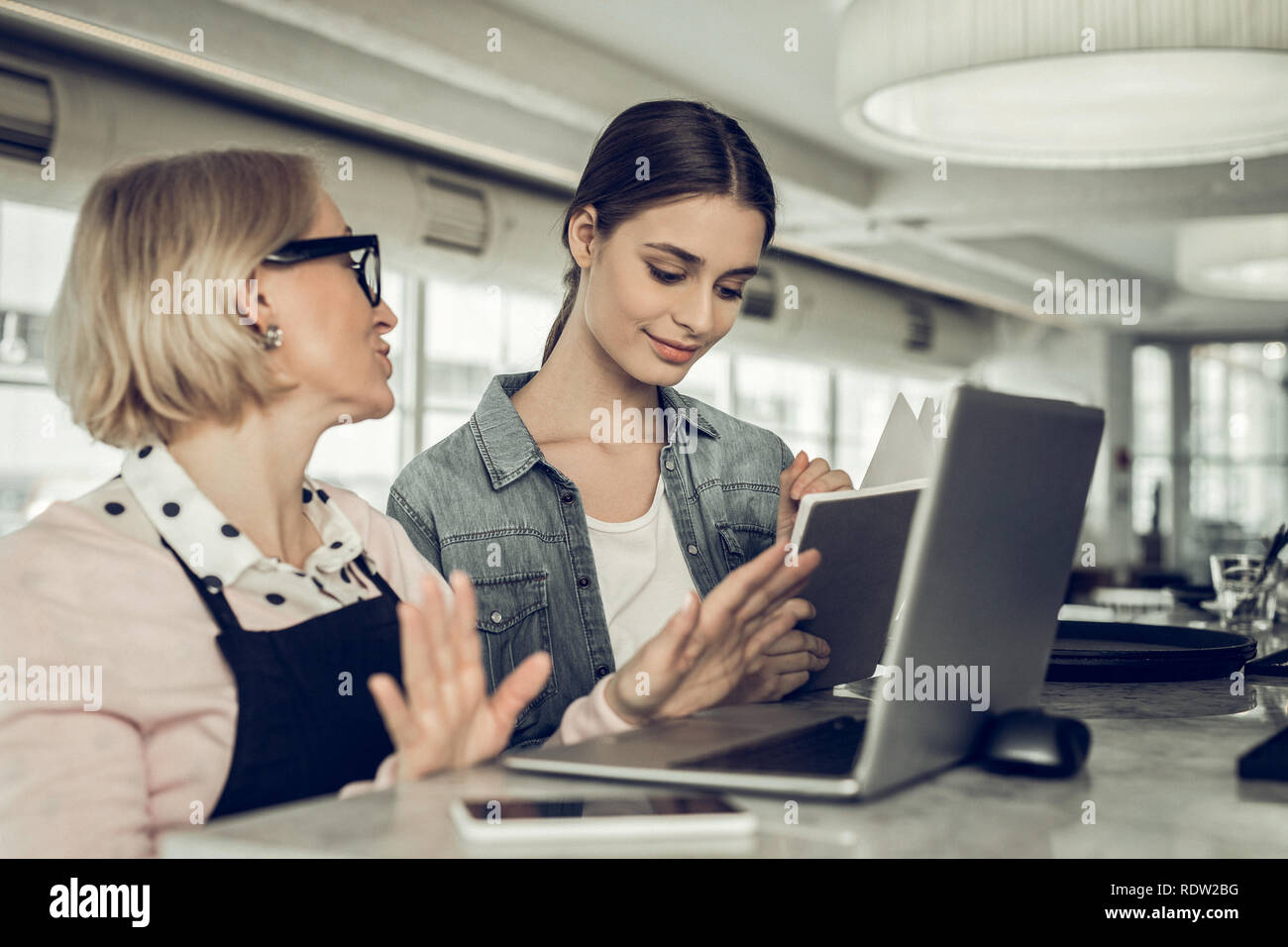 Young waitress coming to job interview with owner of cafe Stock Photo ...