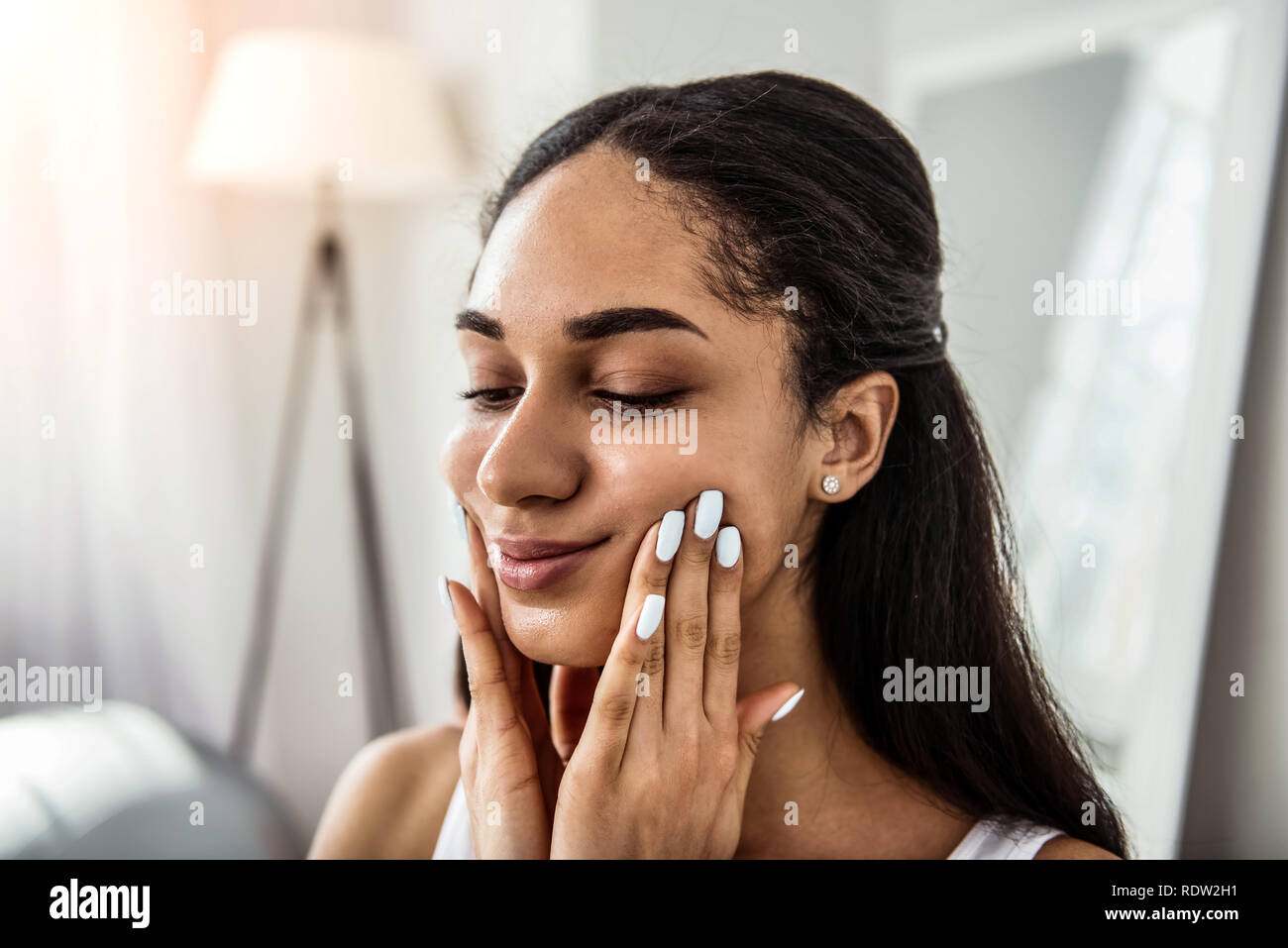 Charming young female person looking downwards Stock Photo - Alamy