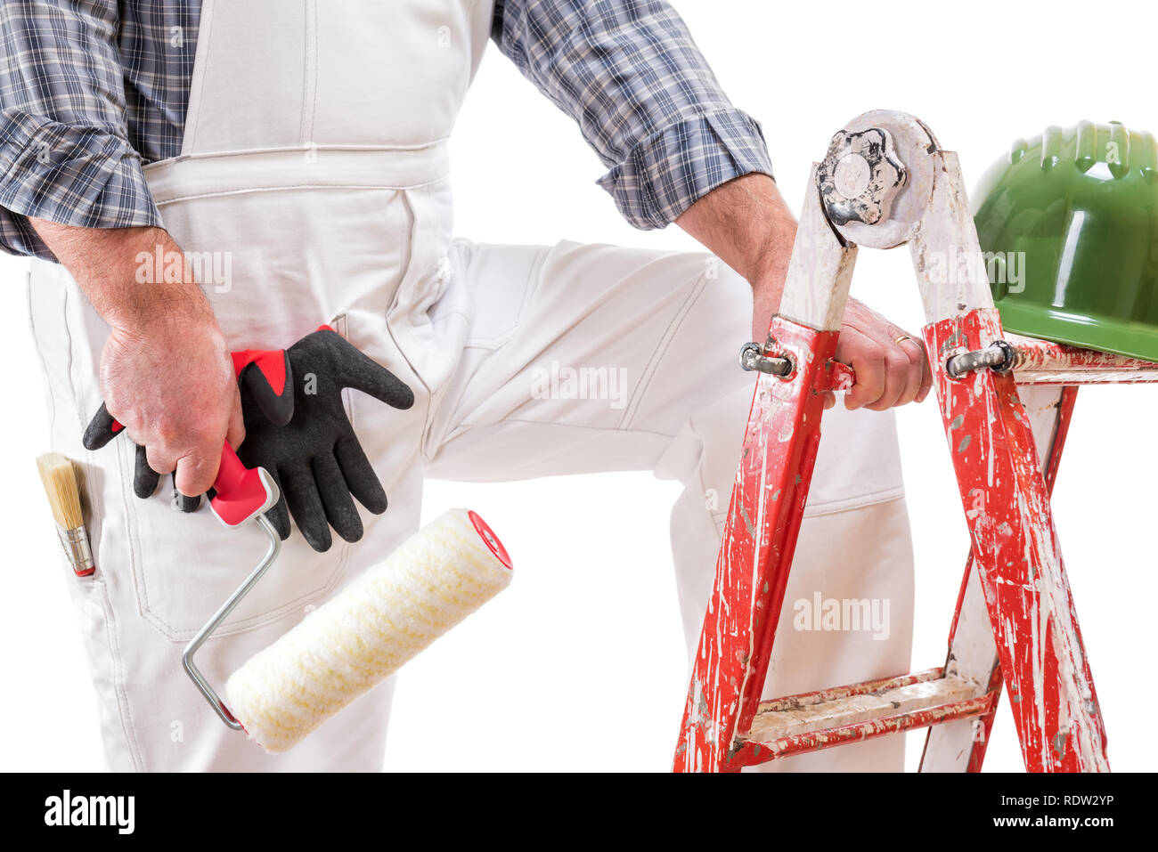 House painter worker on the ladder with white work overalls, keeps the ...