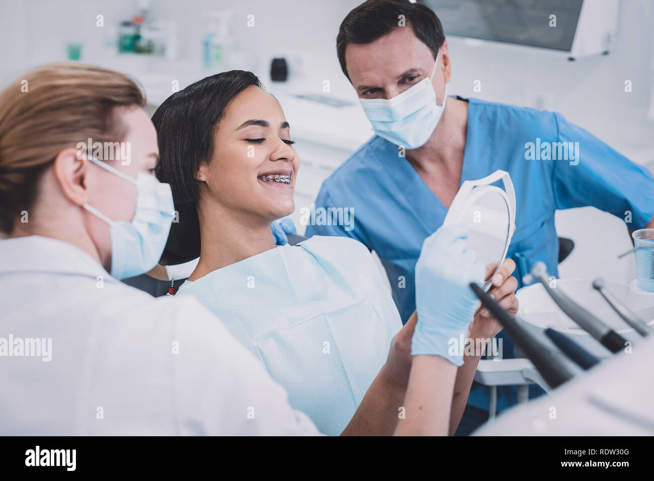 Attentive male person sitting near his patient Stock Photo - Alamy