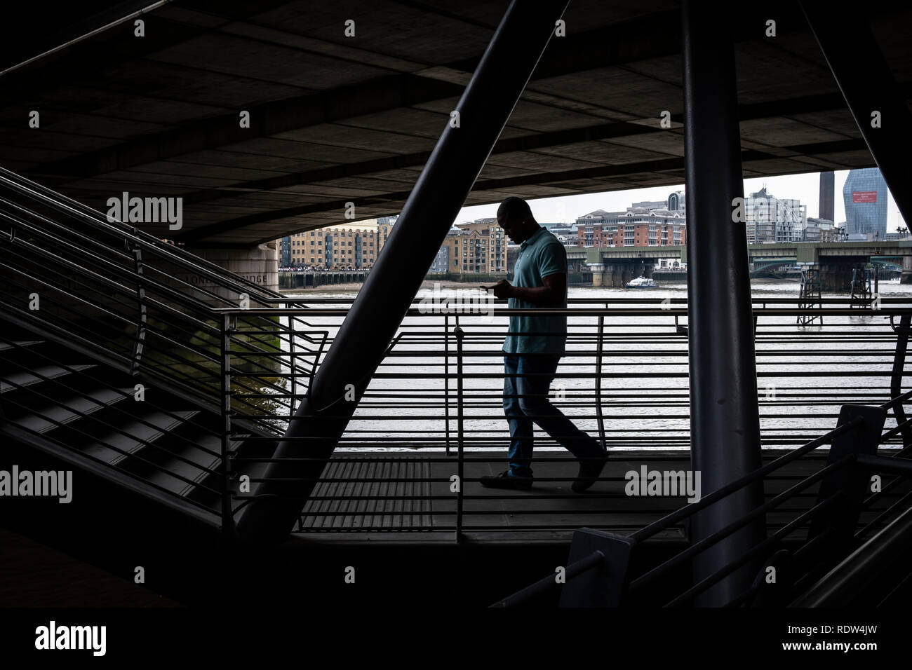 London, England - 10 June 2018: Man walking under London bridge Stock ...
