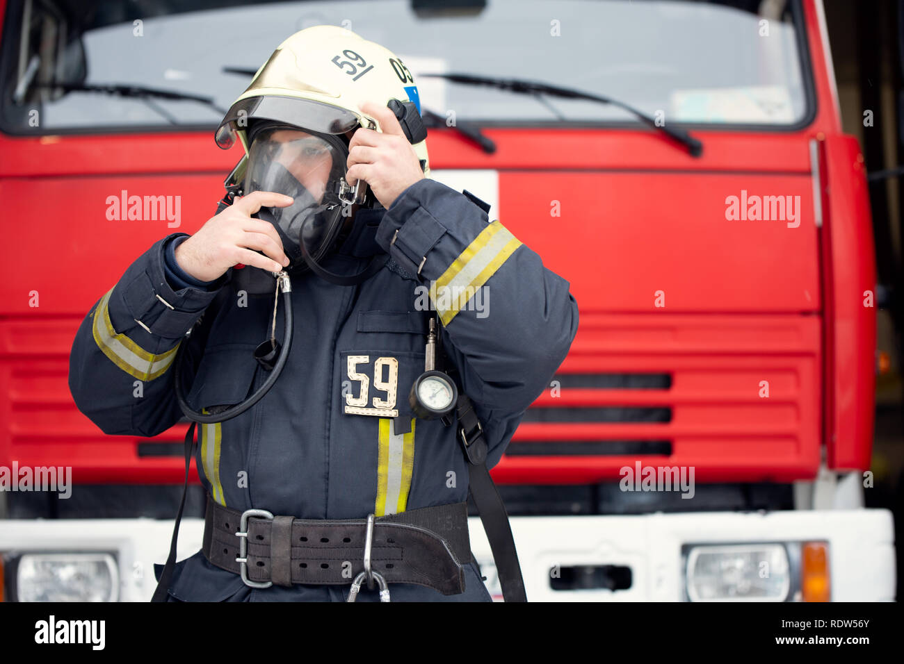 Photo of man fireman in gas mask near fire truck Stock Photo - Alamy