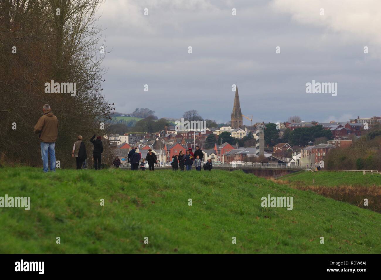 Walkers by River Exe Flood Channel looking towards Exeter on a Winters ...