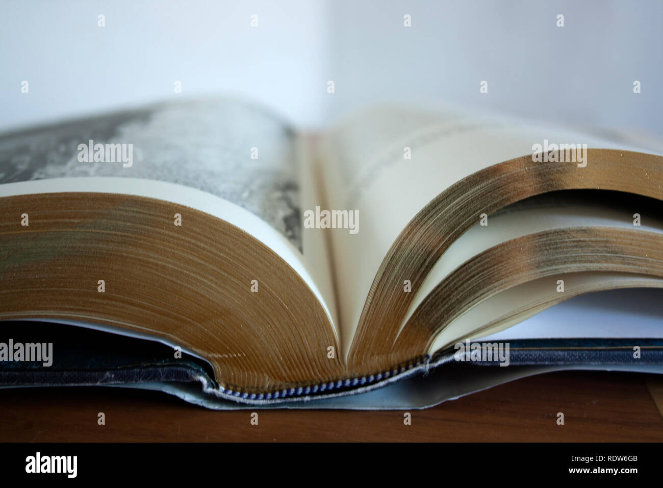 An open book on a table Stock Photo - Alamy