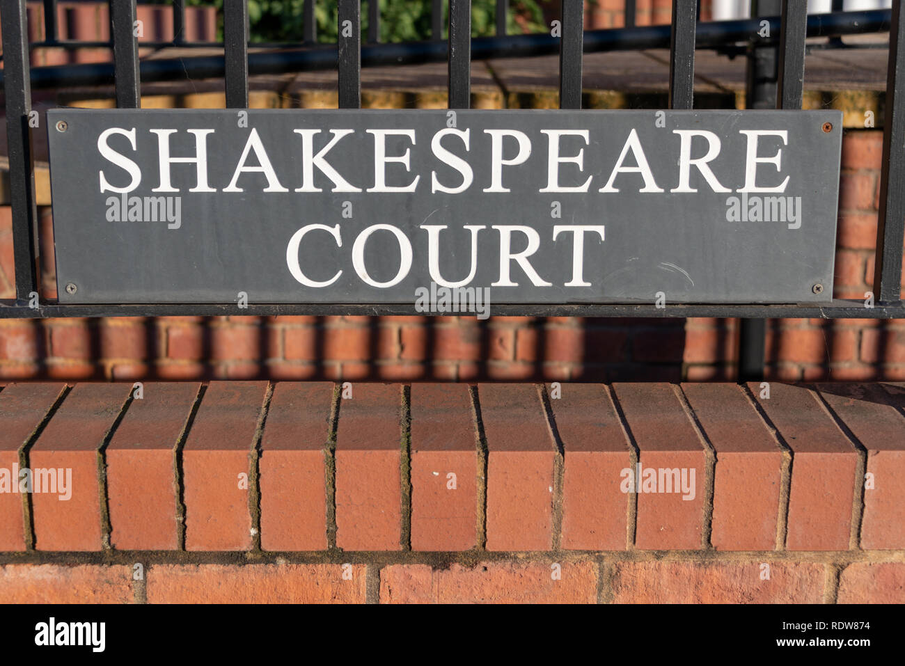black and white Shakespeare COurt sign fixed to metal railings Stock ...