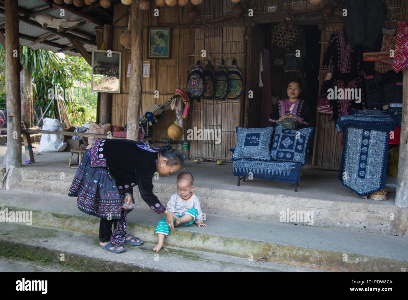 Hmong Thailand woman and baby mother grandmother outside house shop ...