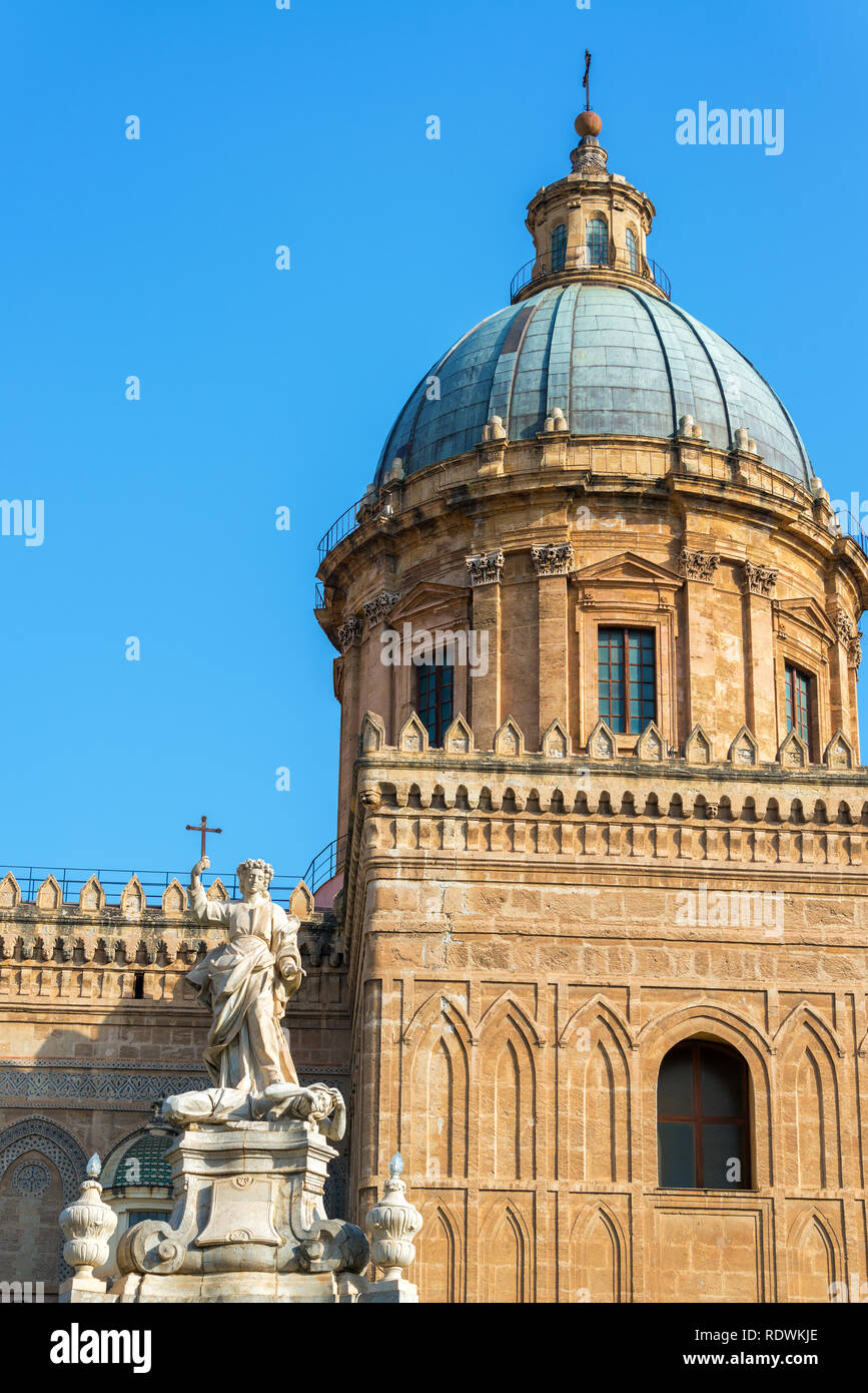 Vertical view of a statue and the dome of the cathedral in Palermo ...