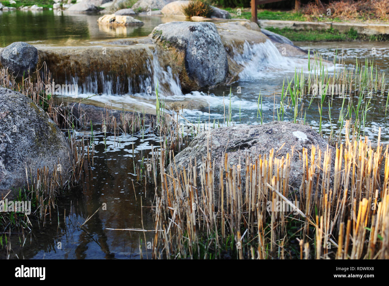 Small waterfall and water pollution in lake Stock Photo - Alamy