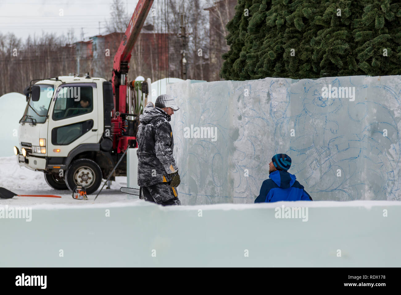 Workers at the construction site of the ice town for a conversation ...