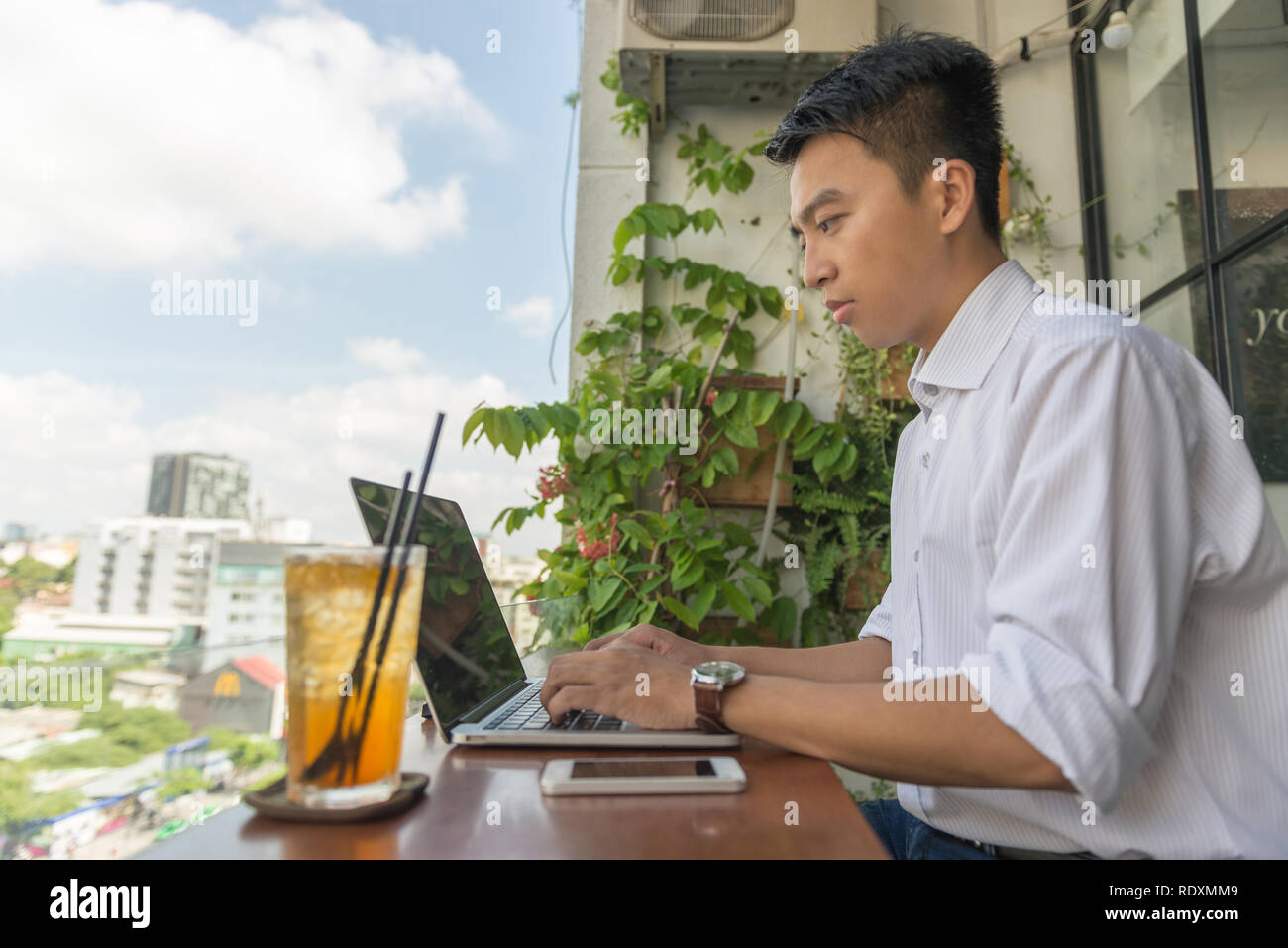 Asian freelancer working on laptop outdoor Stock Photo - Alamy