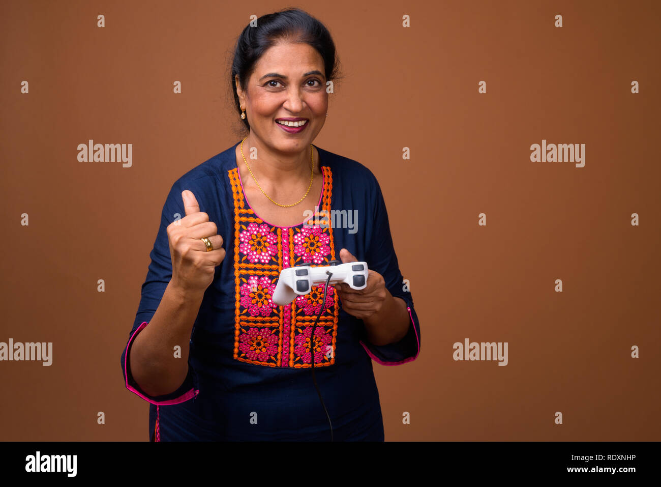 Indian woman playing video games using game controller Stock Photo - Alamy
