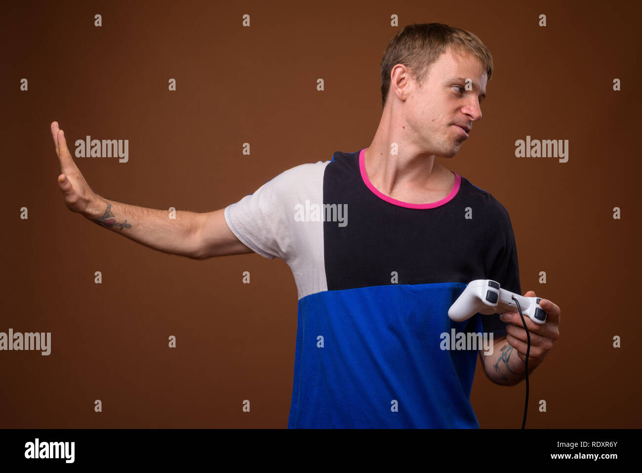 Man playing video games using game controller Stock Photo - Alamy