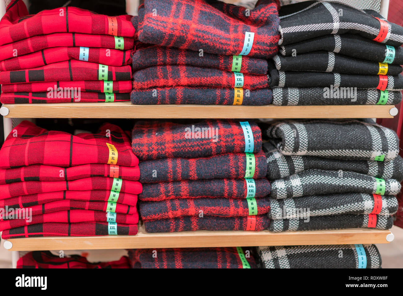 Neatly folded clothes. Rack of clothes with warm. Wooden cabinet with a ...