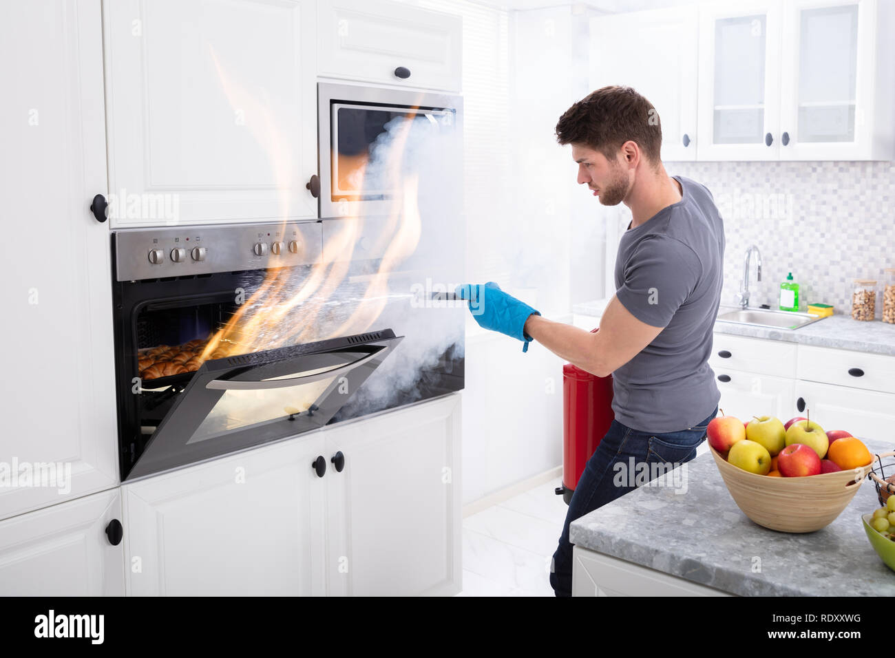 Man using fire extinguisher hi-res stock photography and images - Alamy