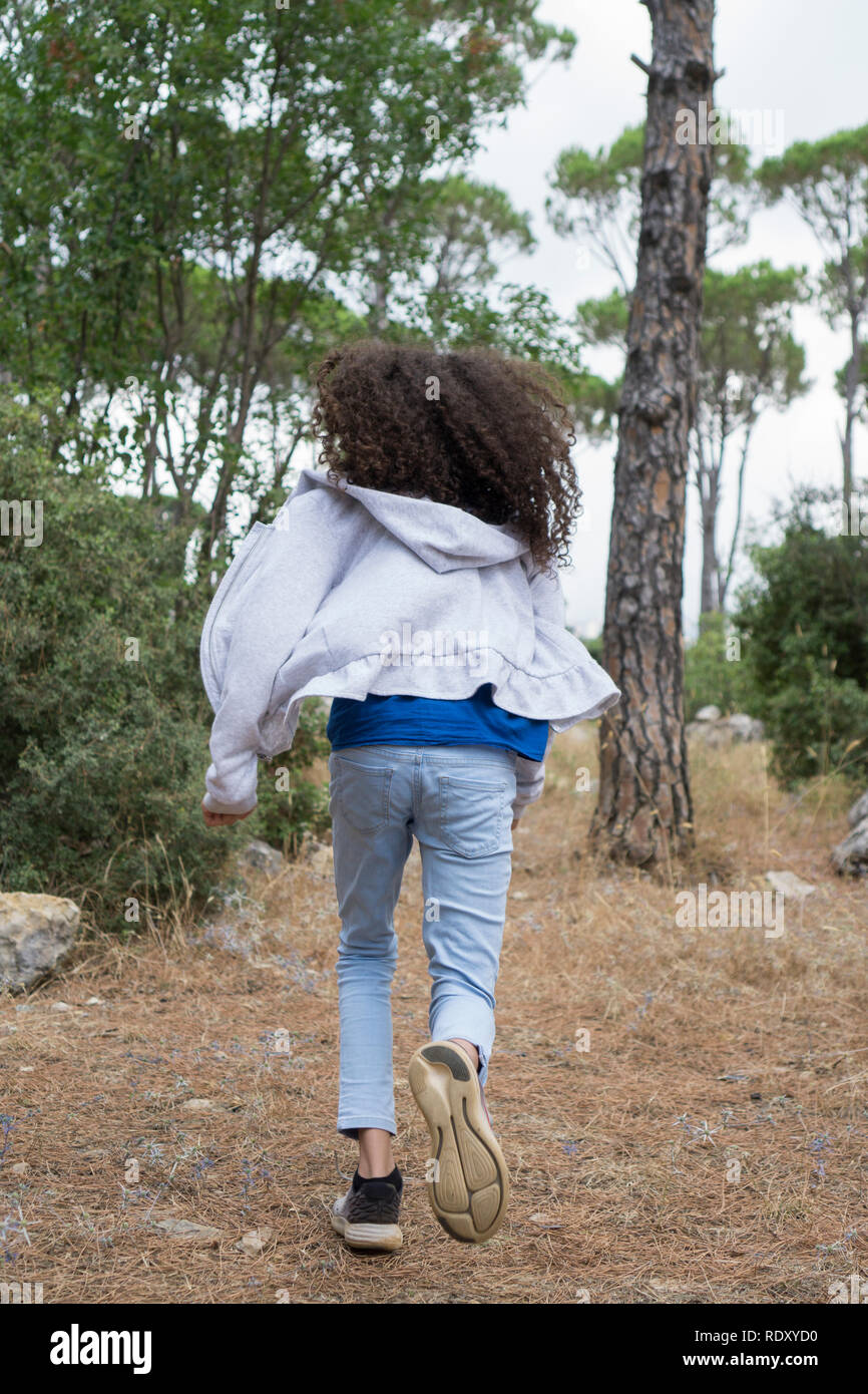 Dark hair girl running away hi-res stock photography and images - Alamy