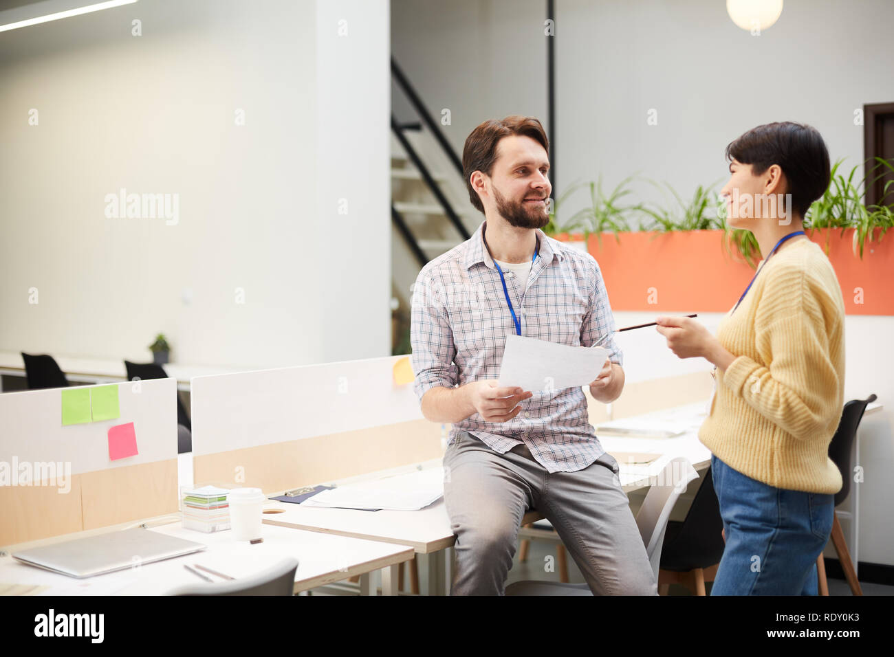 Woman explaining paperwork colleague hi-res stock photography and ...