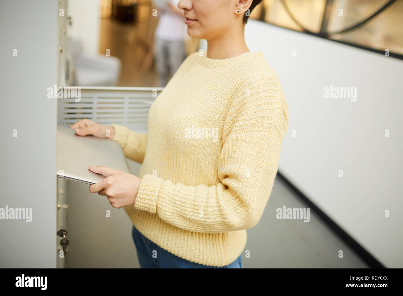 Putting laptop into safe Stock Photo - Alamy