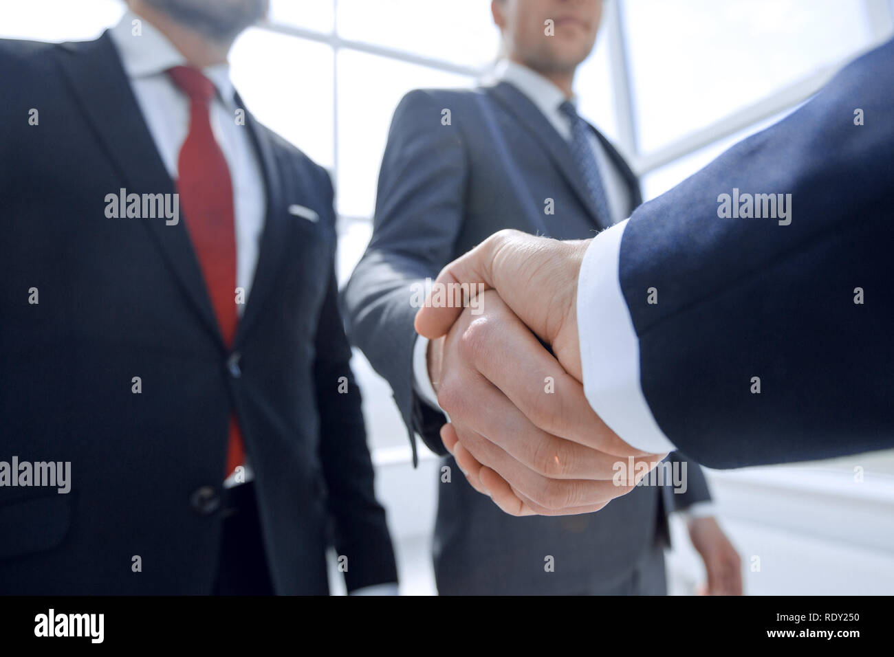 bottom view.businessman reaching out for a handshake Stock Photo - Alamy