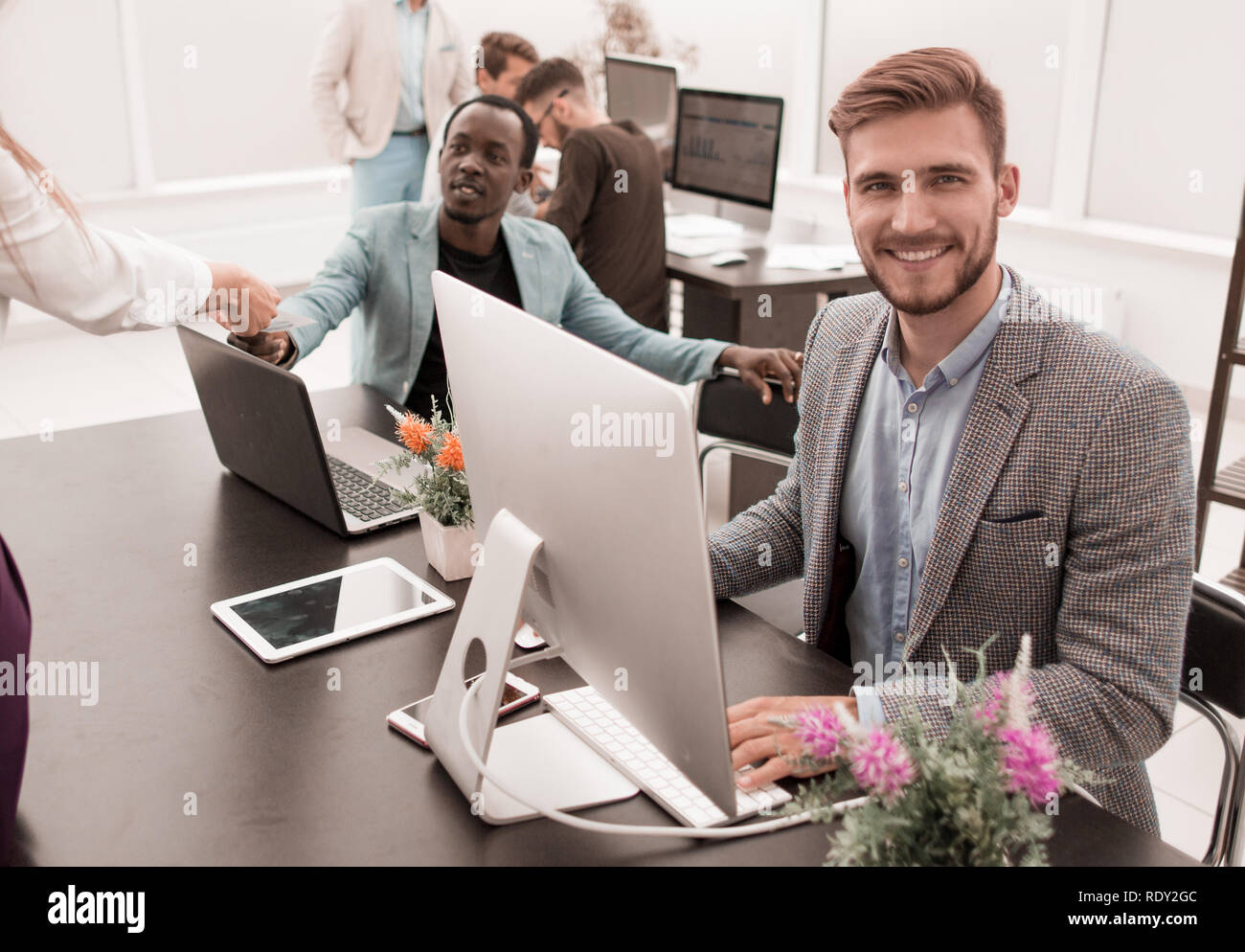 employee sitting at his Desk in the office Stock Photo - Alamy