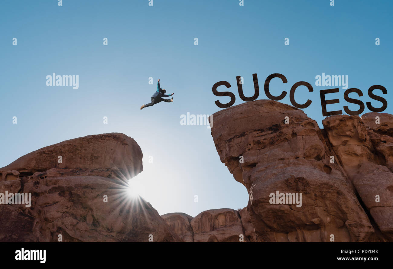 Silhouette a man jumping over precipice to success.Business success ...