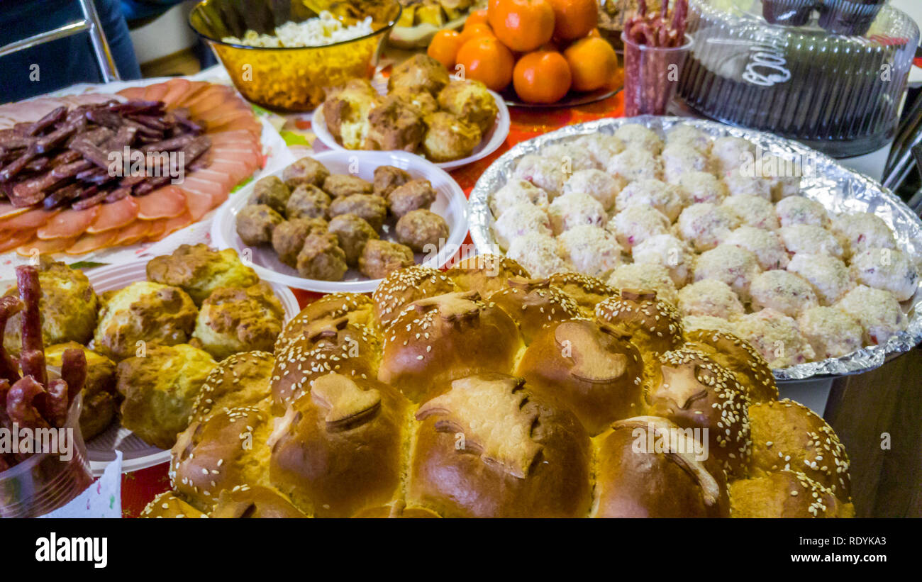Rich table spread with many different dishes, fruits and deserts Stock ...