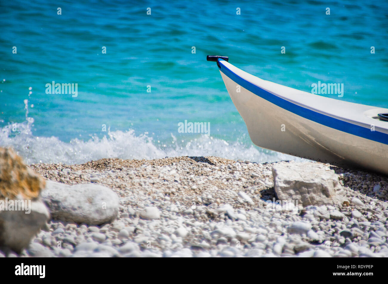 Pebble beach with boat hi-res stock photography and images - Alamy