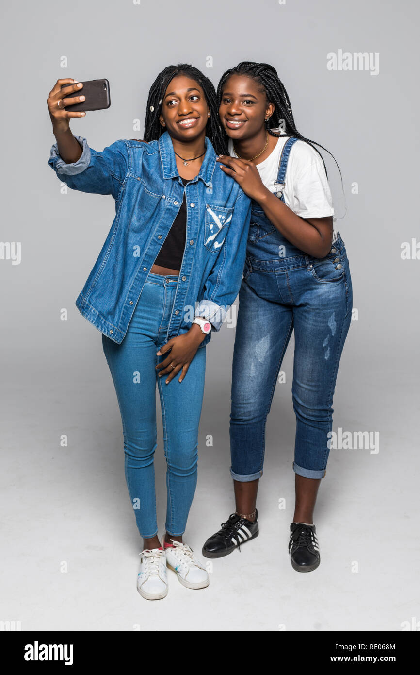 Photo Of A Two Pretty Happy Young African Women Make Selfie Posing Over