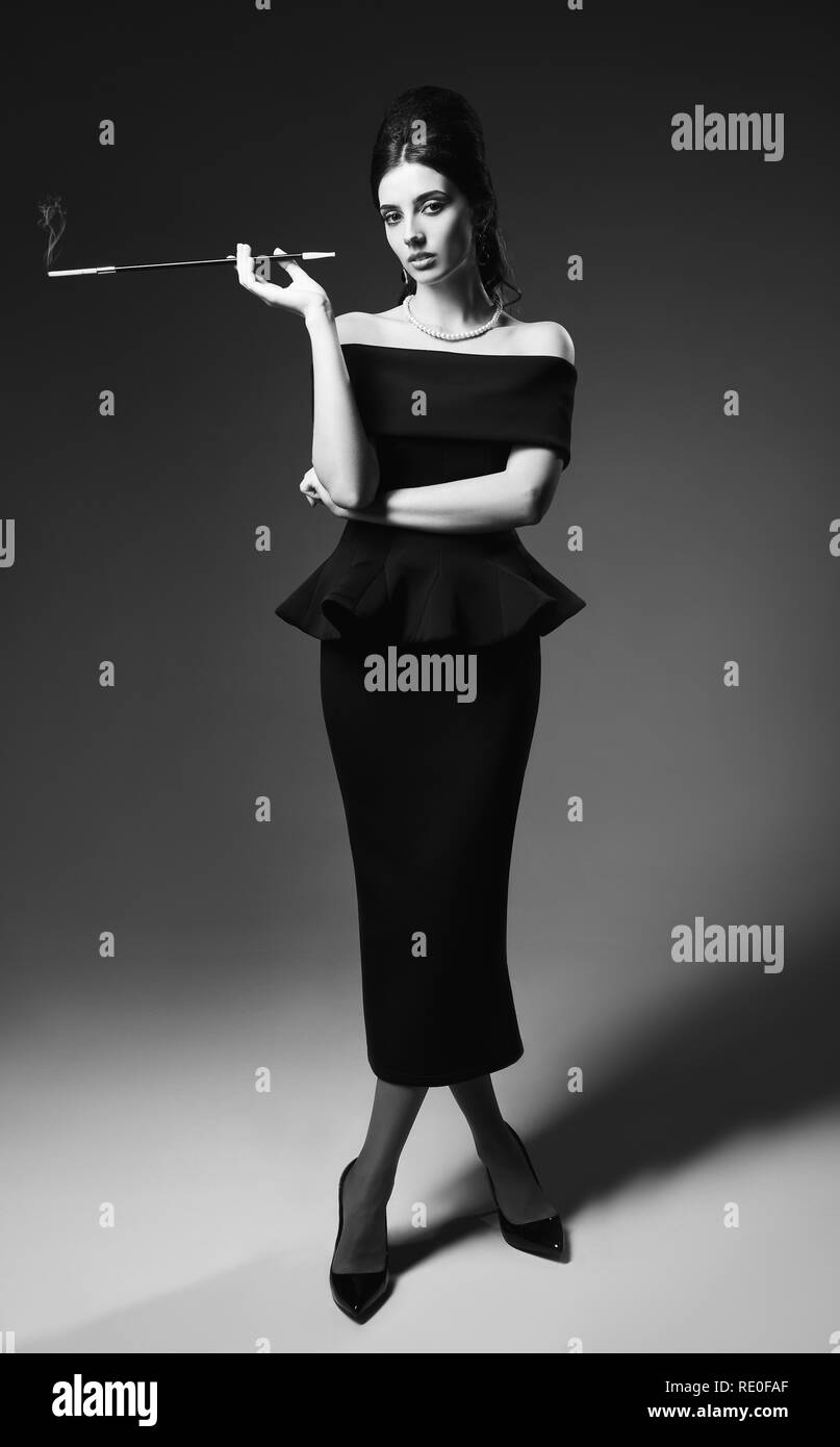 Retro shot: the beautiful young woman smoking cigarette. Vintage ...