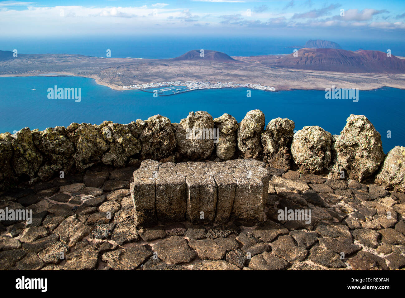A stone bench overlooking La Graciosa island from Mirador del Rio on ...