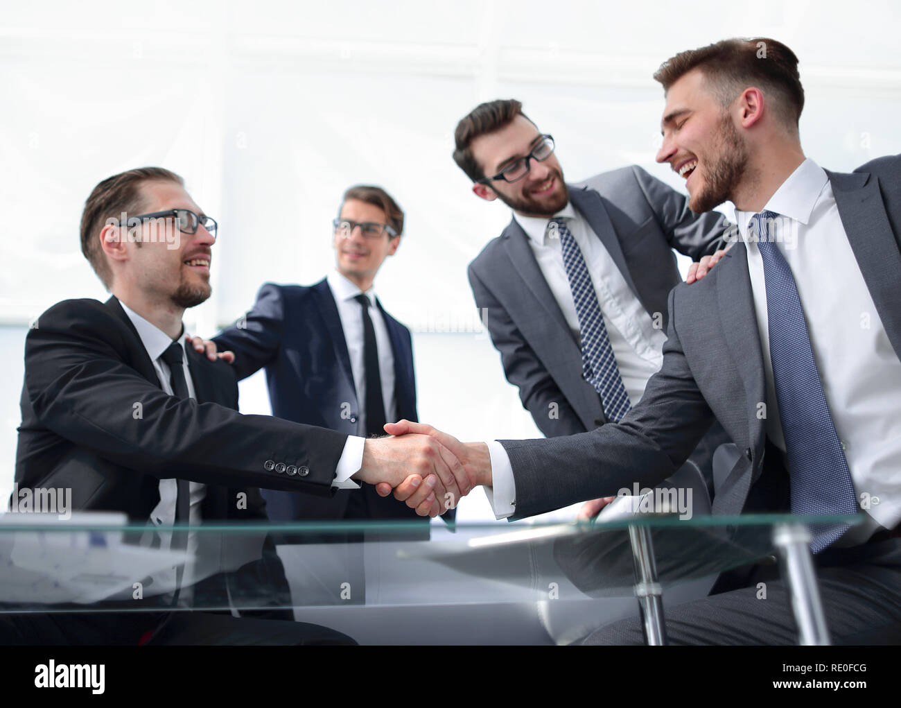 confident handshake business partners at the Desk Stock Photo - Alamy