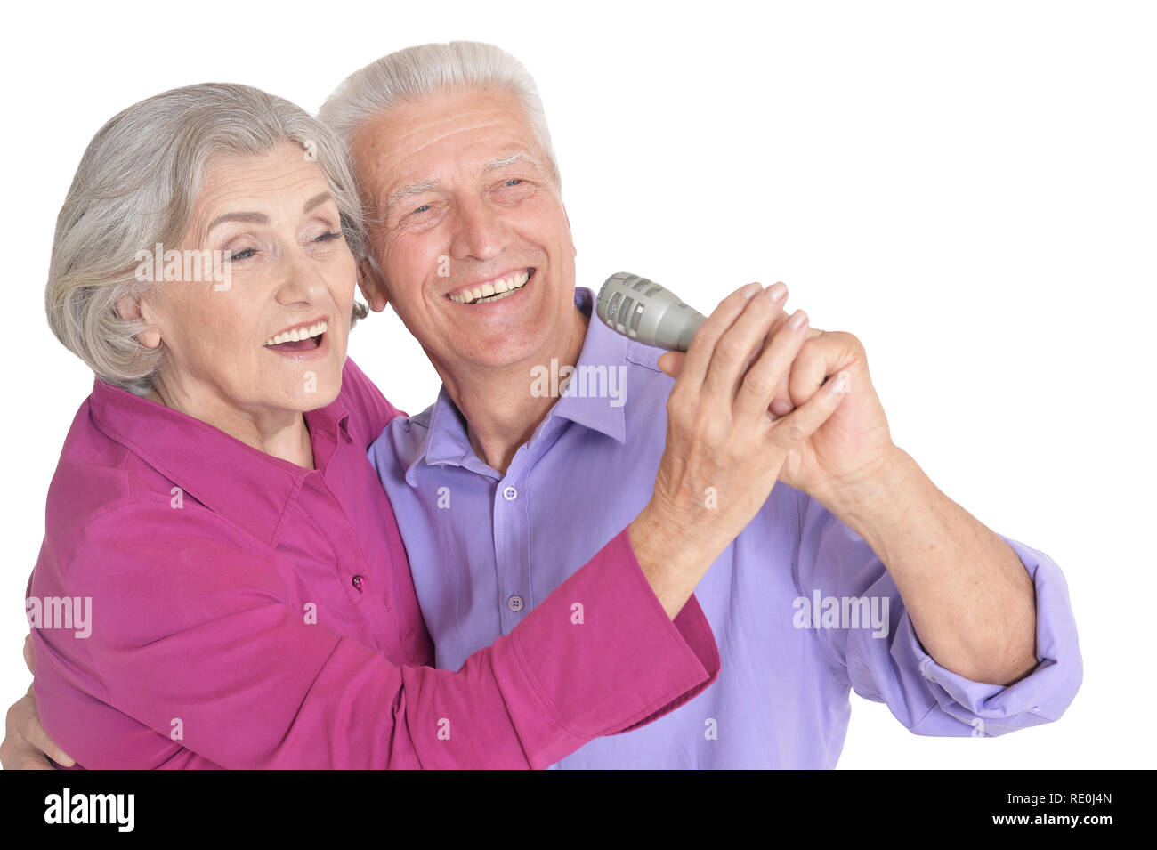 Senior couple singing karaoke on white background Stock Photo - Alamy