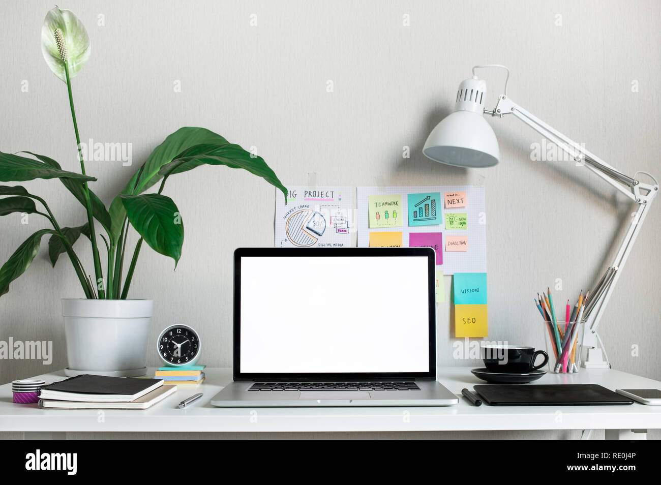 Modern work table with blank computer laptop and accessories in home ...