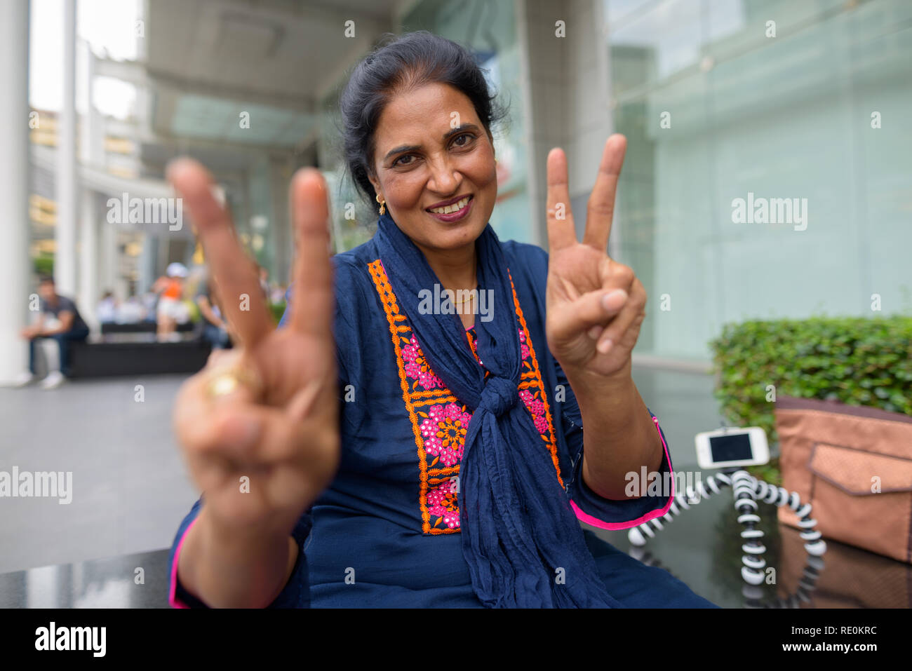 Woman making peace sign hi-res stock photography and images - Alamy