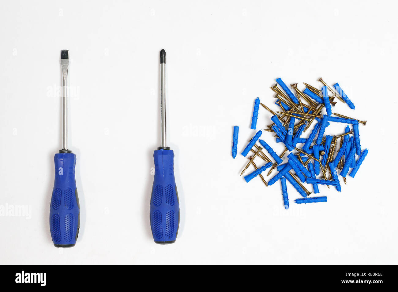 Blue hand screwdrivers and screws isolated on white background. Top ...