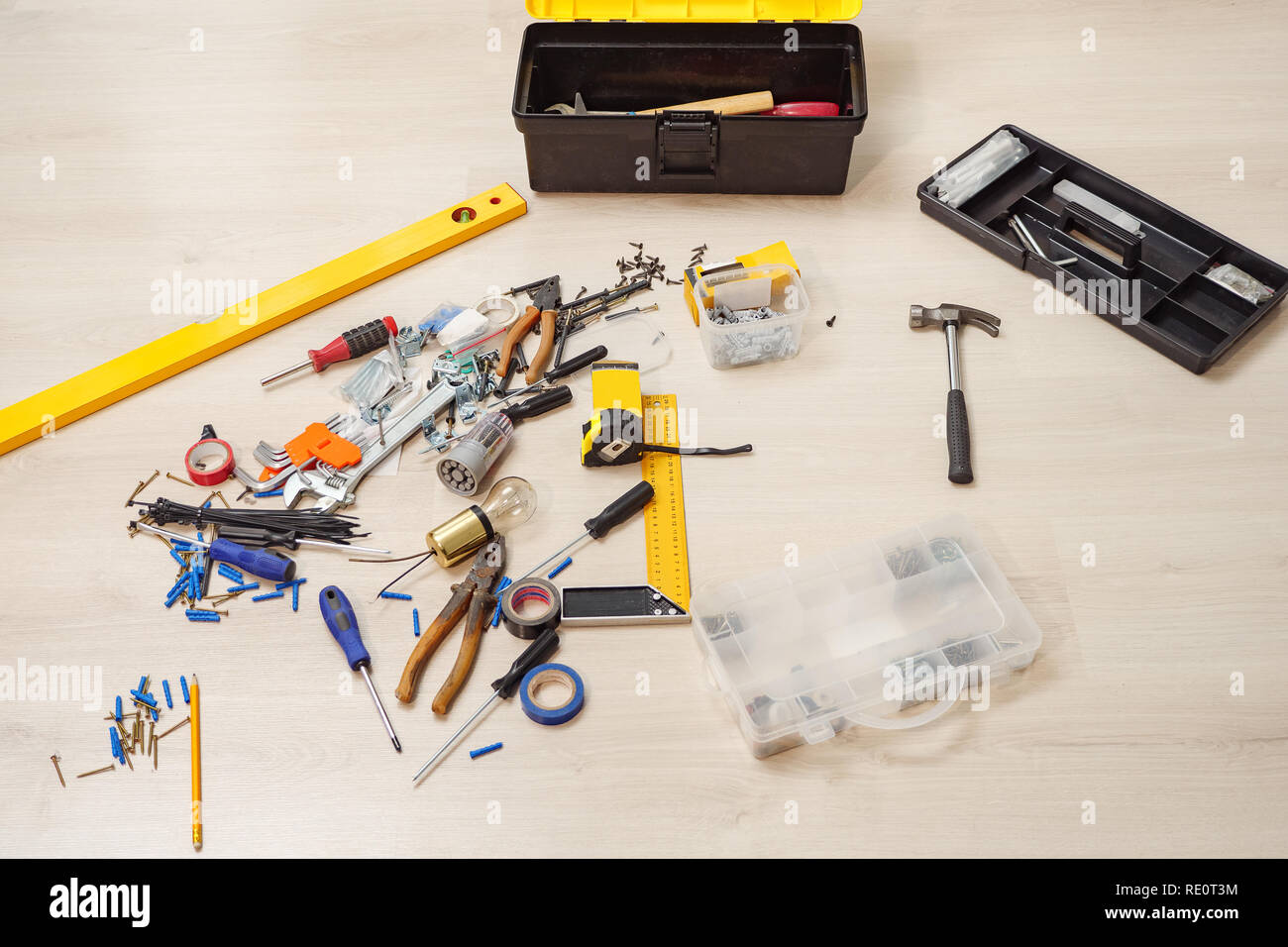 Chaotic arrangement of tools and instruments on wooden floor with ...